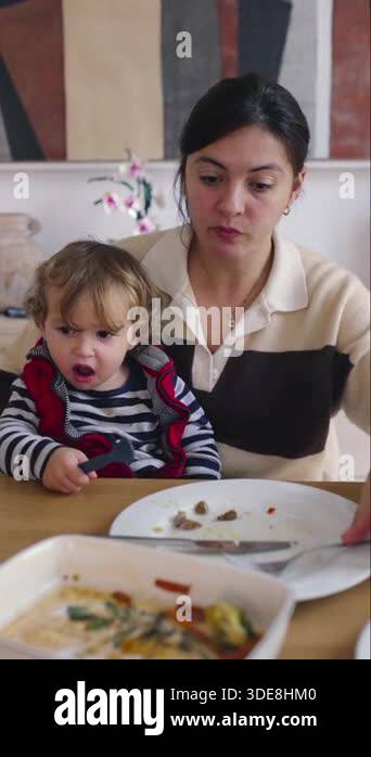 Parent and young child eat together showing guidance routine and calm ...