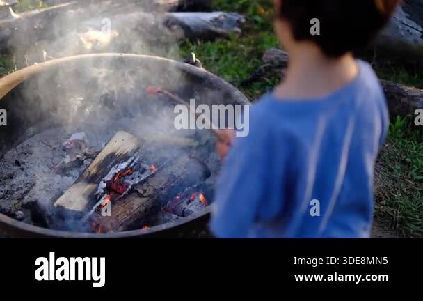 cute boy roasting marshmallows over fire pit Stock Video Footage - Alamy