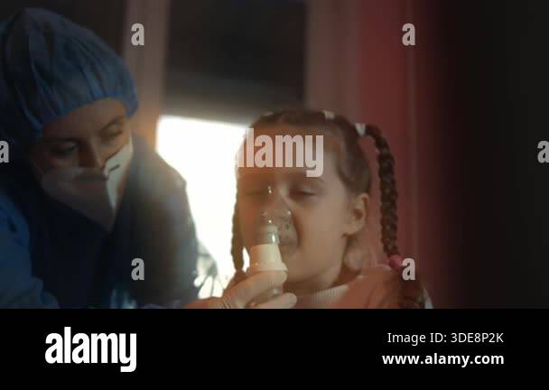 Doctor is holding the nebulizer mask on the face of a little girl Stock ...