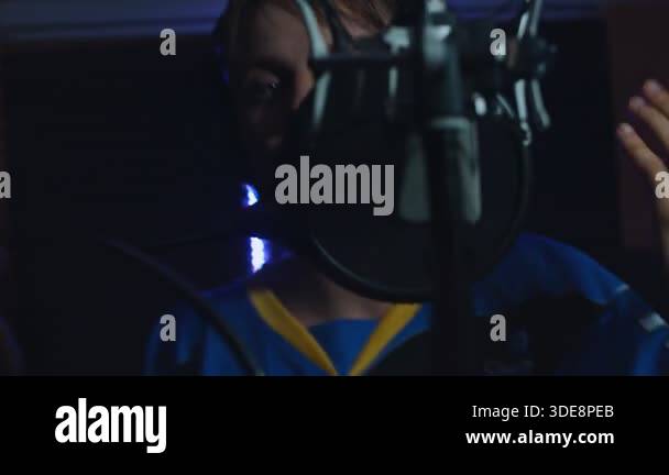 Male rap singer recording a new song in the music recording studio ...