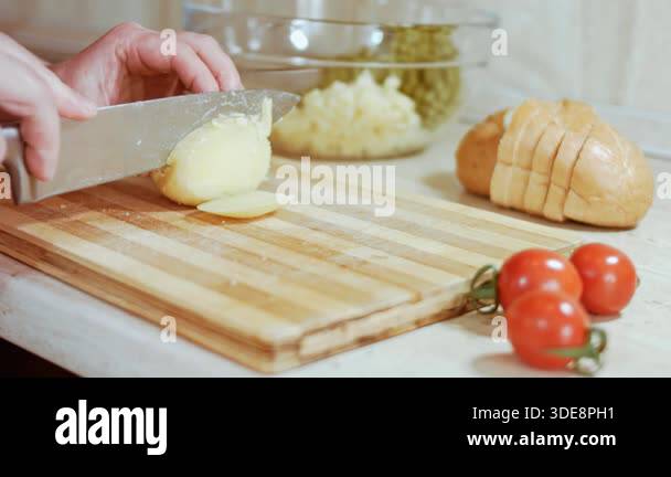 Cutting boiled potatoes on a wooden cutting board Stock Video Footage ...