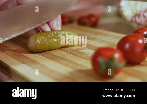 Cutting pickled cucumber on a wooden cutting board Stock Video Footage ...