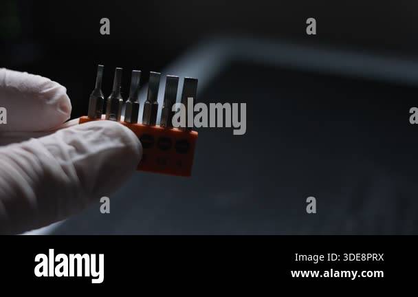Set of bits for a screwdriver in hand Stock Video Footage - Alamy