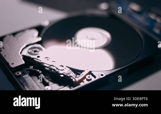 Working opened hard disk drive with a spinning magnetic disk Stock ...