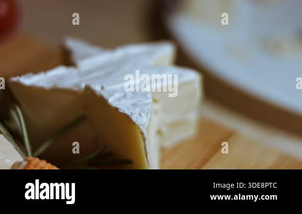 Star shaped Brie soft cheese on a wooden charcuterie board Stock Video ...