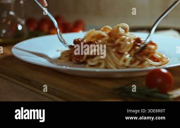 Mixing the spaghetti with red meat sauce Stock Video Footage - Alamy