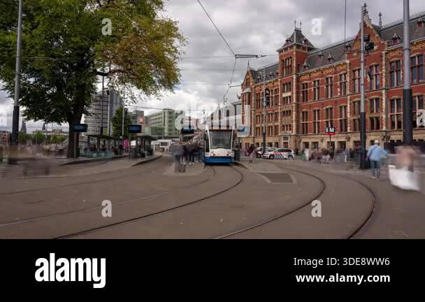 Time lapse of trams and people in front of the main central station in ...