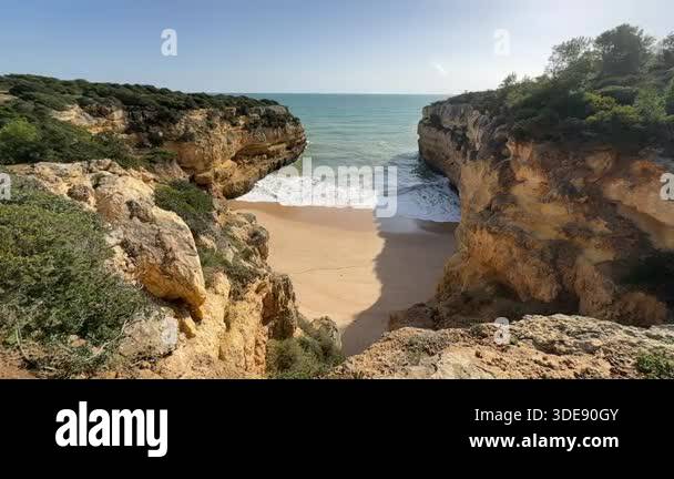 Beautiful Fontainhas Beach surrounded by yellow cliffs, Algarve ...