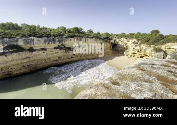 Beautiful Fontainhas Beach surrounded by yellow cliffs, Algarve ...