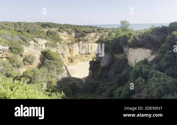 Beautiful Fontainhas Beach surrounded by yellow cliffs, Algarve ...