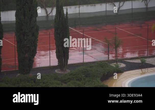 Wet Surface of Clay Tennis Court with Large Rain Water Puddle . High ...