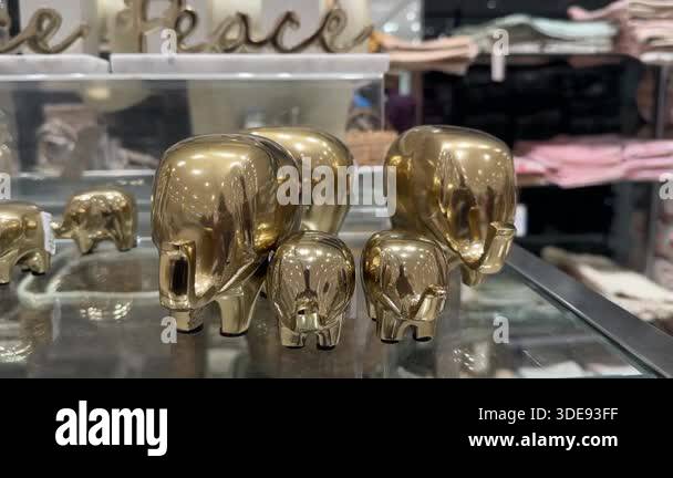 Home decor golden metal elephant family over glass table. Interior ...