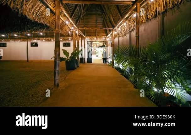 Point of view walking through an illuminated outdoor hallway of a ...