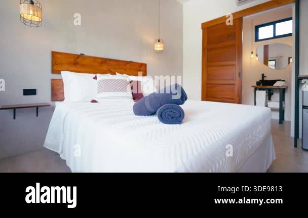 Stylish and modern hotel bedroom interior with a comfortable queen size ...