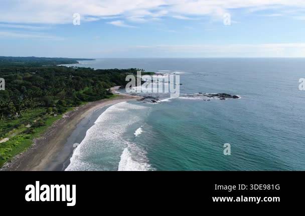Beautiful drone footage showing a scenic sandy beach with gentle waves ...