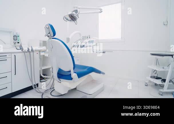 White, sterile, and modern dental clinic interior. Empty blue patient ...