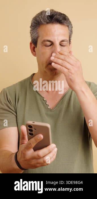 Worried man with gray hair using his mobile phone, showing a range of ...