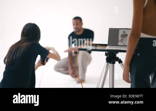 Professional female photographer capturing stylized portrait of male ...