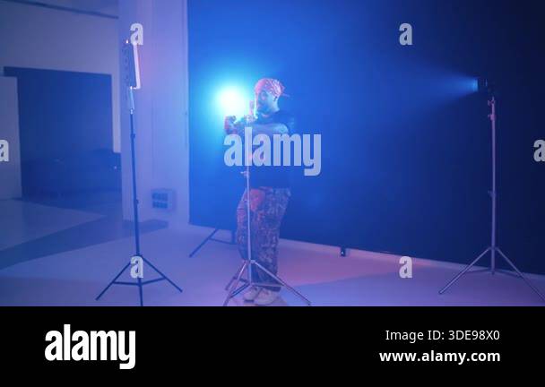 Charismatic reggaeton singer performing in front of a microphone ...