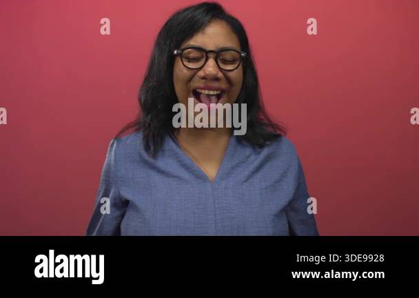 African american woman wearing glasses calling with hand by mouth in ...