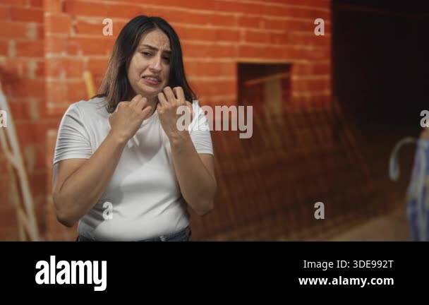 Young woman in white t shirt clutching chest for heartattack inside ...