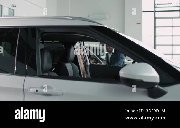 African American man in a suit is engaging with a Caucasian woman ...