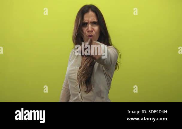 Woman pointing finger at camera with furrowed brow and stern face in ...