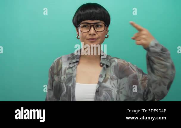 Young chinese woman with glasses pointing at nose against an isolated ...