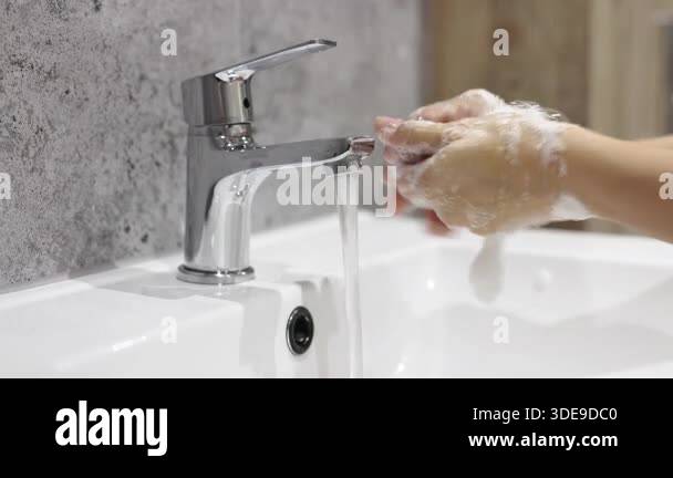 Person washing hands at modern sink Stock Video Footage - Alamy
