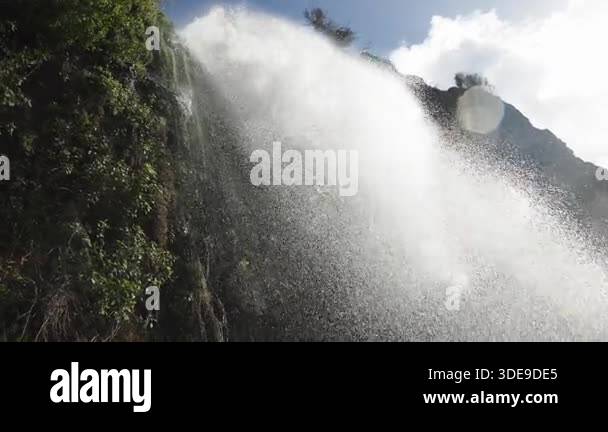 Waterfall cascading down rocky cliff Stock Video Footage - Alamy