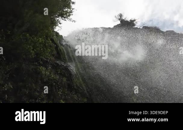 Waterfall cascading down rocky cliffside Stock Video Footage - Alamy