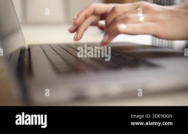 Person typing on laptop keyboard at home Stock Video Footage - Alamy