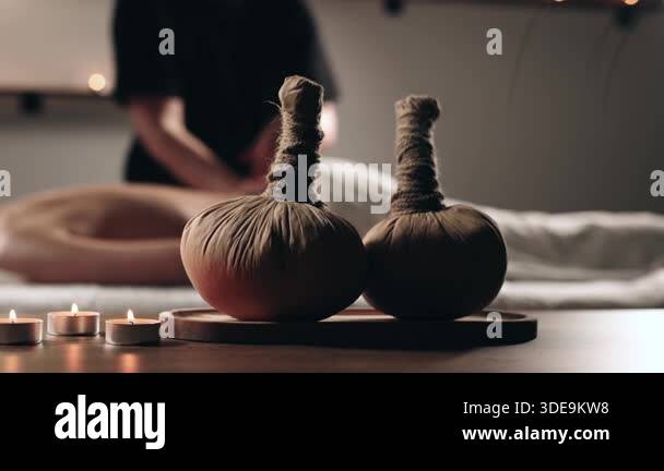 Ayurveda Massage therapist with herbal bolus bags onto female skin ...