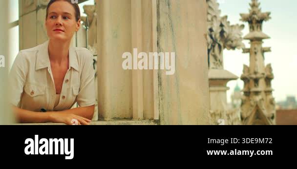 Woman observing architecture stone railing at rooftop of Duomo di ...
