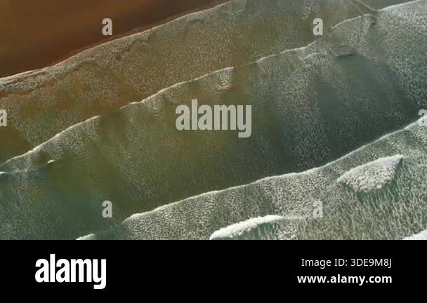 Aerial view of Pacific ocean waves forming textures on tropical sandy ...