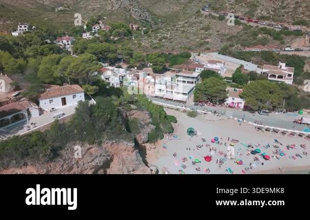 Drone footage of Cala Granadella beach with colorful umbrellas, white ...