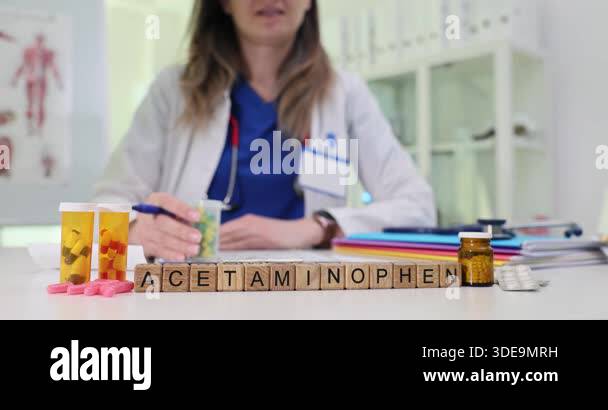 Wooden blocks spell word Acetaminophen beside pill bottles on medical ...