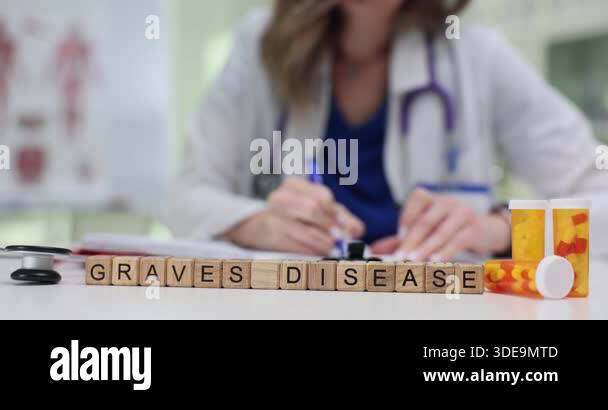 Wooden blocks spell words Graves Disease on medical table near pill ...