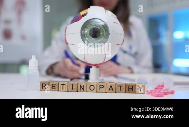 Text Retinopathy on wood cubes among pills drops and eyeball model on ...