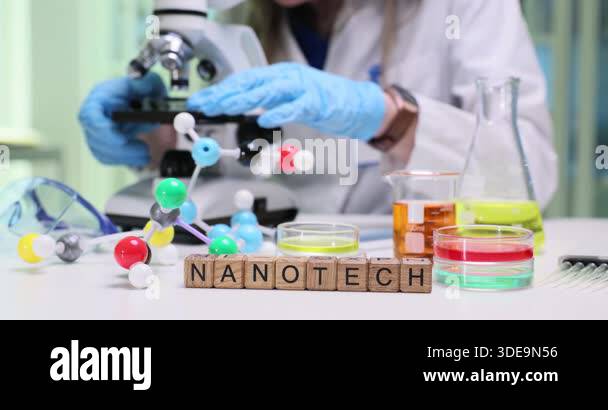 Woman lab technician uses microscope to study delicate structures of ...