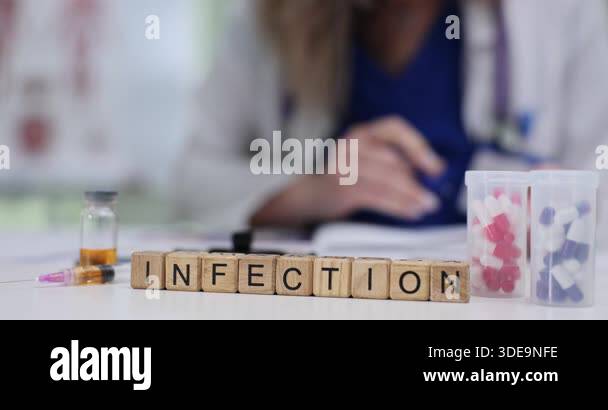 Wooden blocks spell word Infection near vial and plastic box with ...