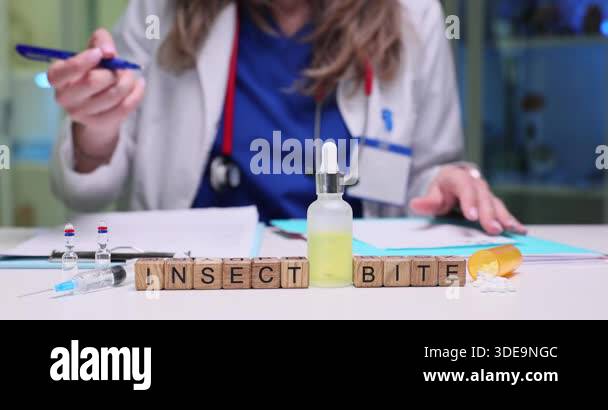 Wooden blocks on desk spell words Insect Bite beside dropper bottle ...