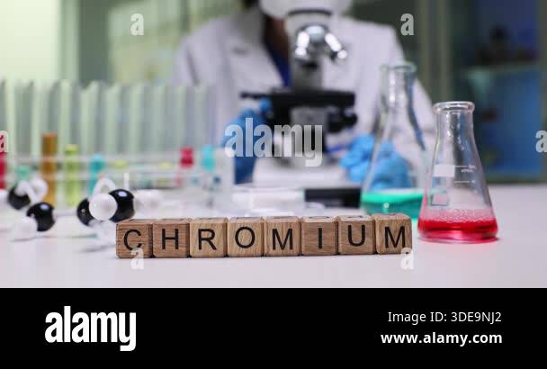 Wooden blocks on table spell word Chromium near bright reagents in ...