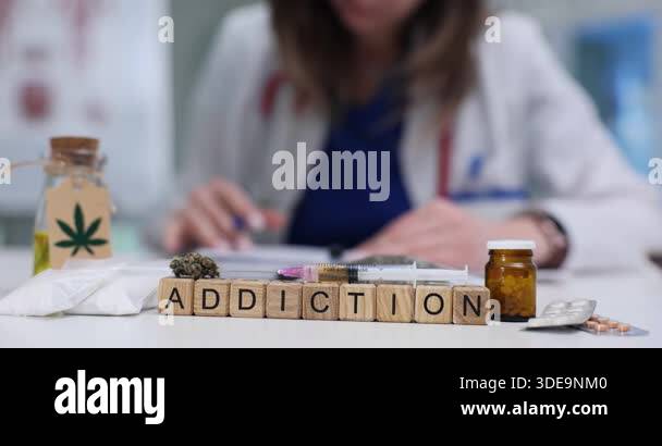 Wooden blocks on medical desk spell word Addiction near cannabis ...