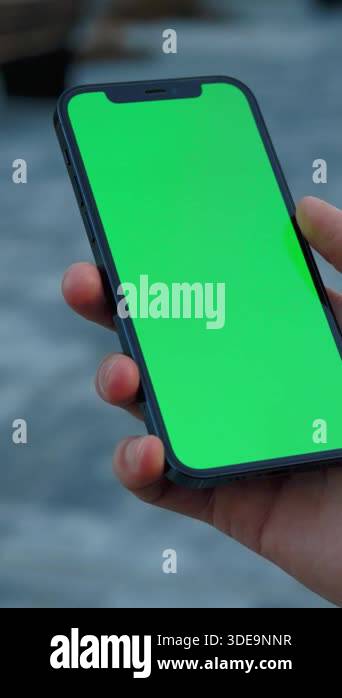 A mobile phone showcasing a vivid bright green screen, ideal for ...
