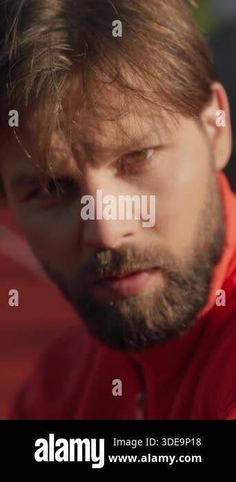 white man closeup intense gaze sweat dirt fleck on nose beard sunlit ...