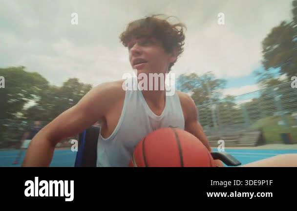 young athlete on court holding basketball, sunny afternoon POV camera ...