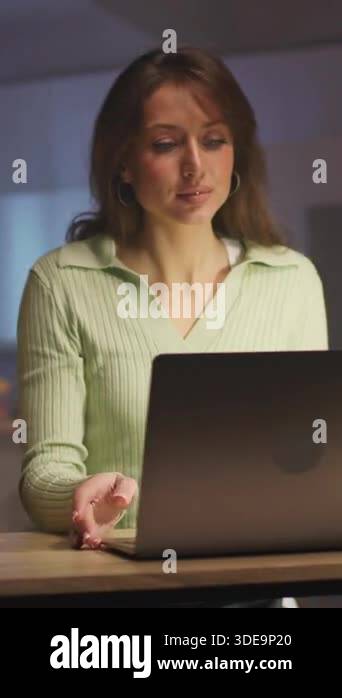 white woman at laptop in study, soft lamp glow and concentrated ...