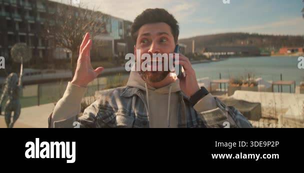 man by waterfront animated phone call, startup founder celebrating deal ...