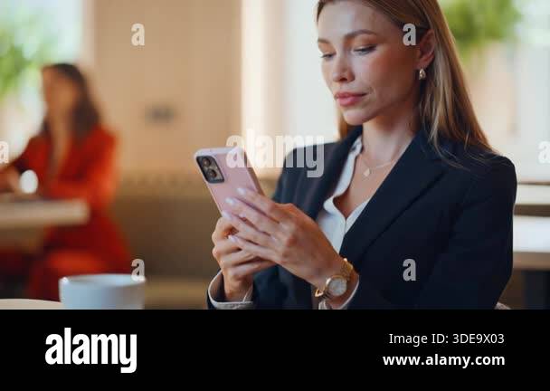 Rich lady texting mobile phone sitting restaurant table with coffee cup ...